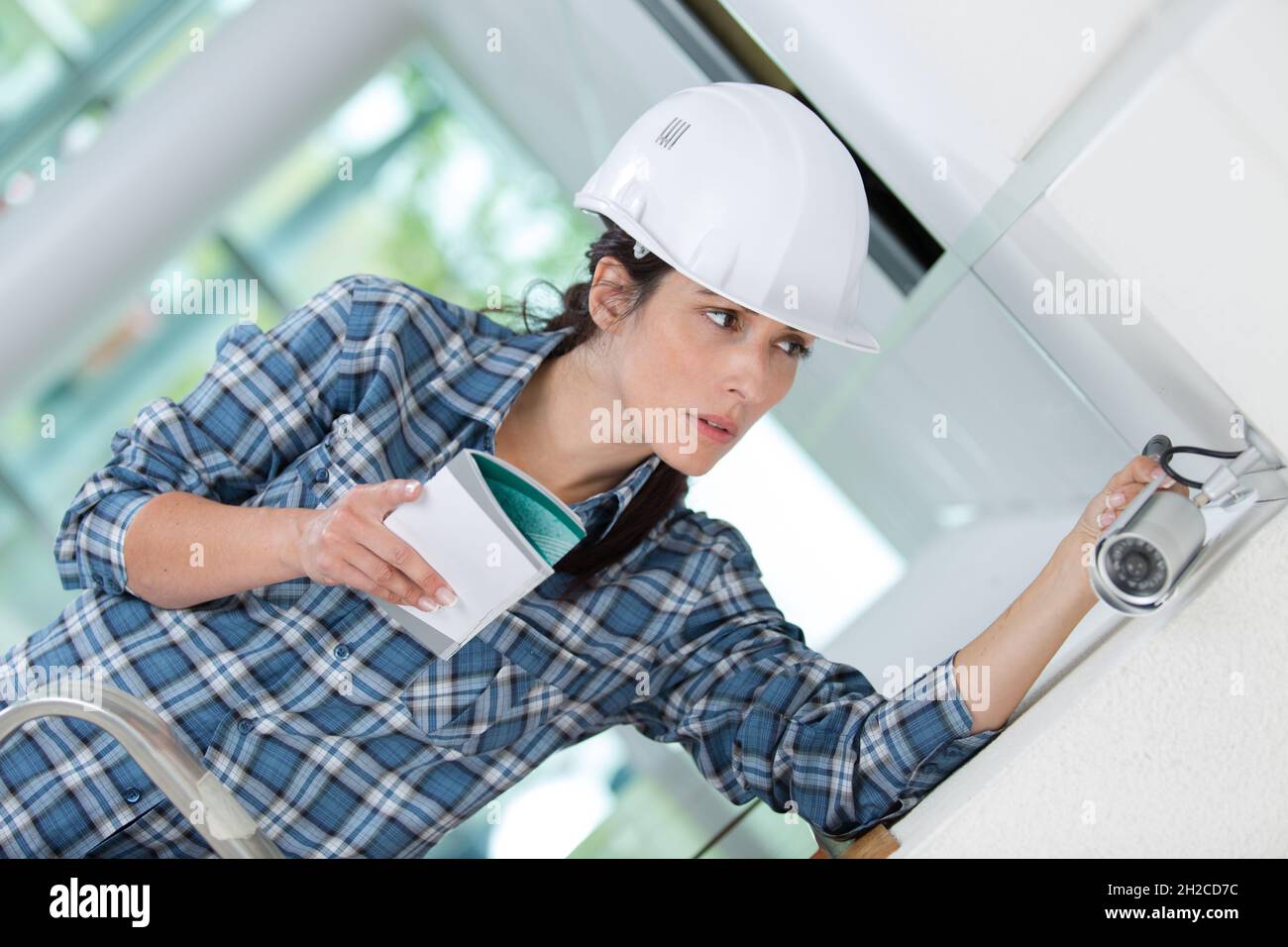 female professional cctv technician working Stock Photo - Alamy