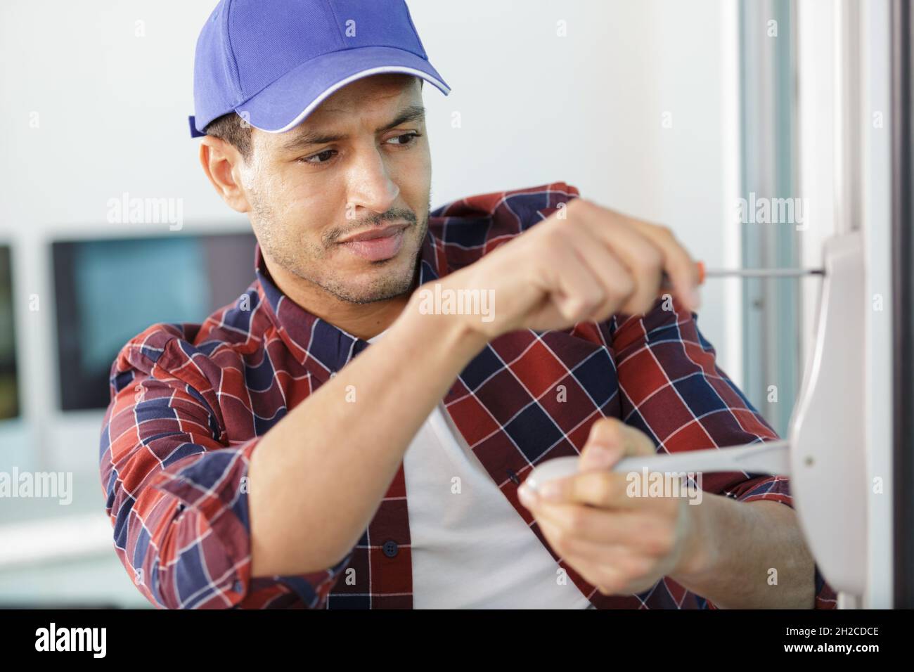 a young handyman repair window Stock Photo - Alamy