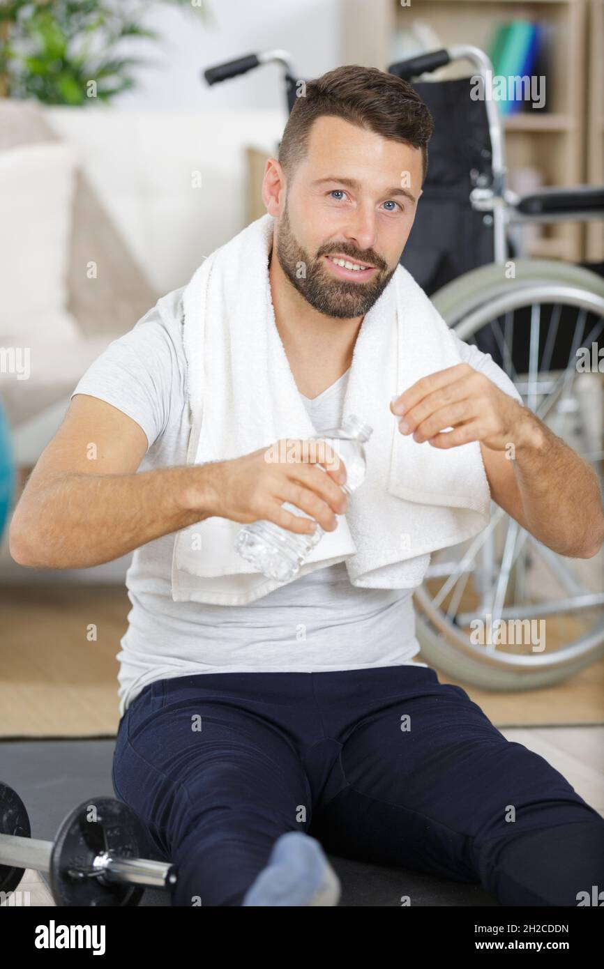 happy disabled man in wheelchair doing rehabilitation sport exercises ...