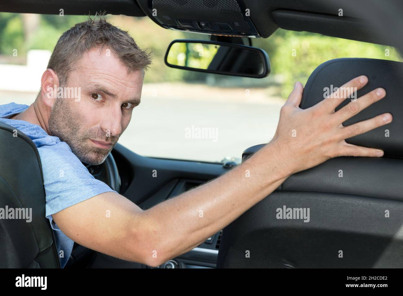 handsome man driver looking back and parking car Stock Photo - Alamy