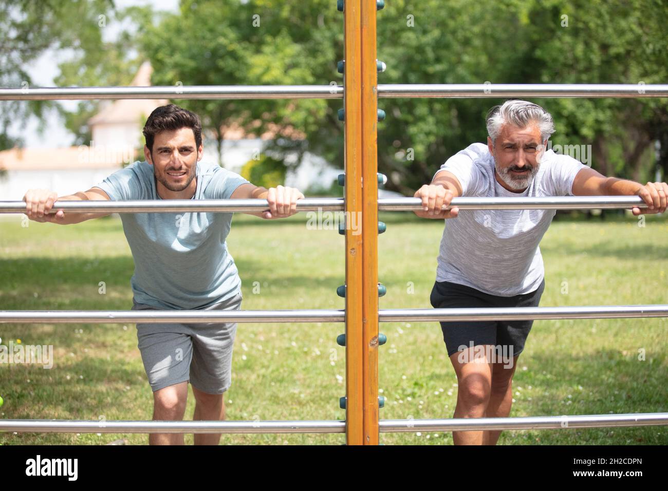 male friends doing exercise in the park Stock Photo - Alamy