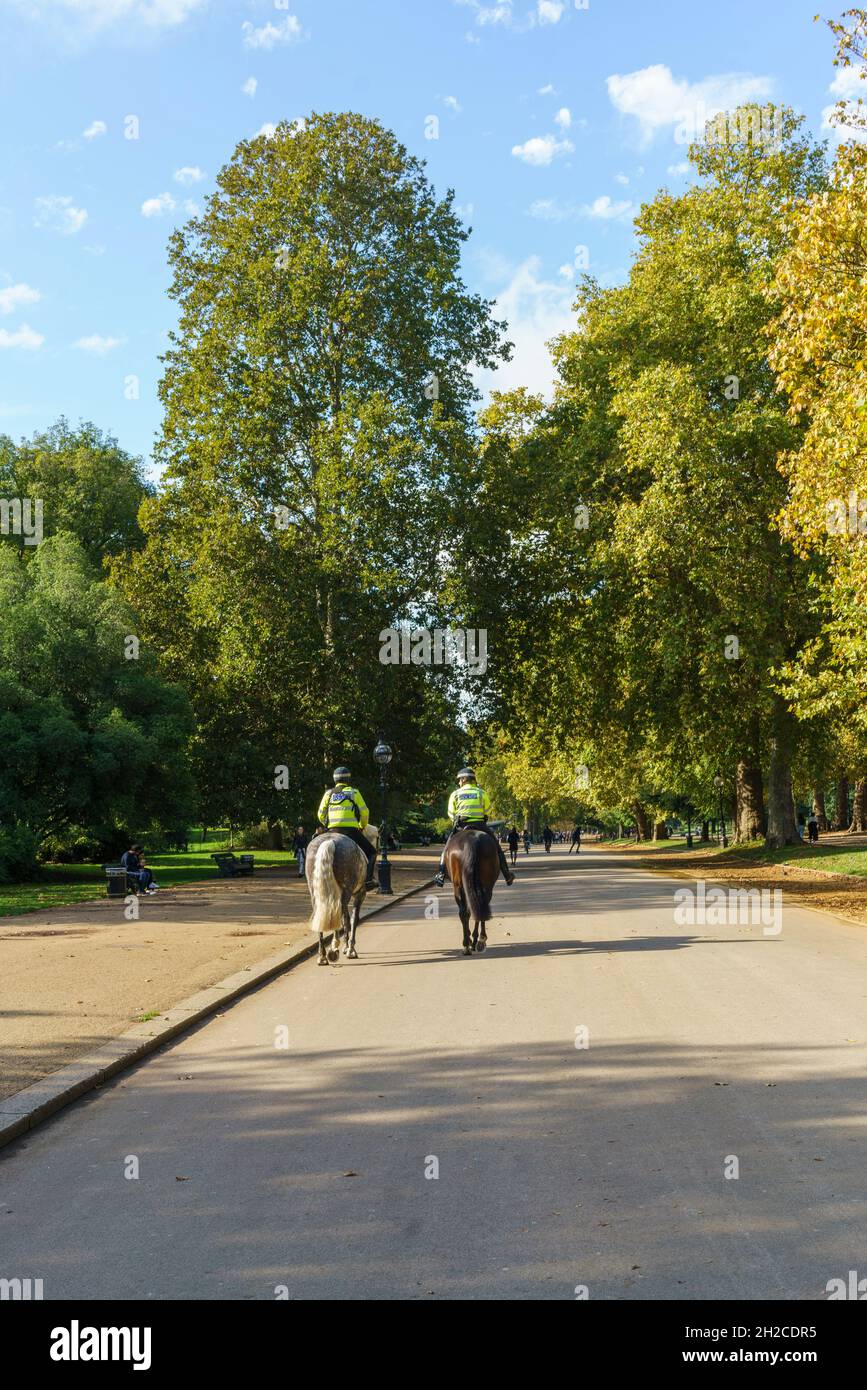 Two mounted police officers patrolling Regent's Park in London Stock ...
