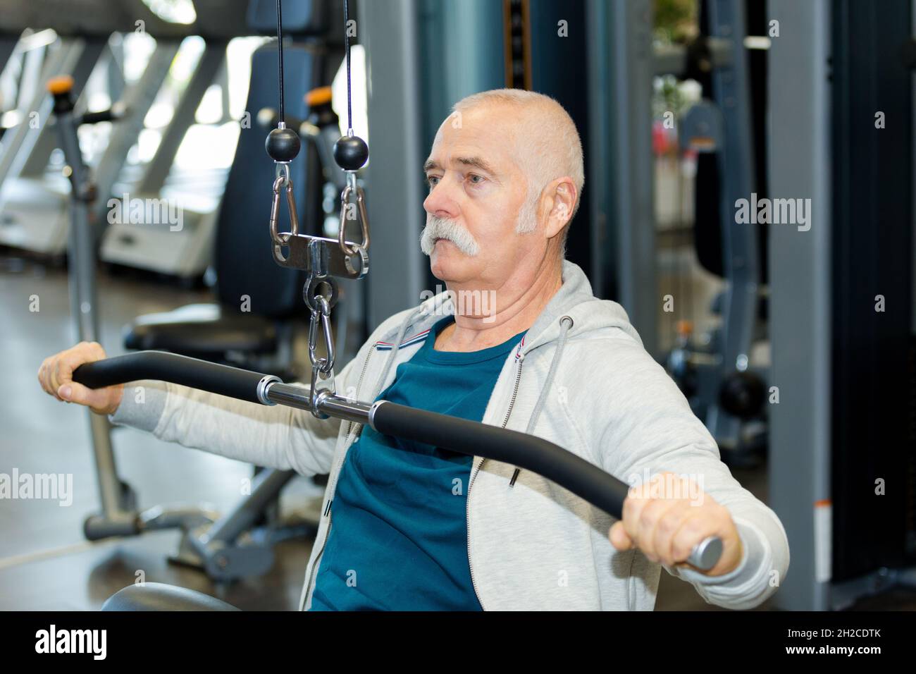 senior man in gym working out with weights Stock Photo - Alamy