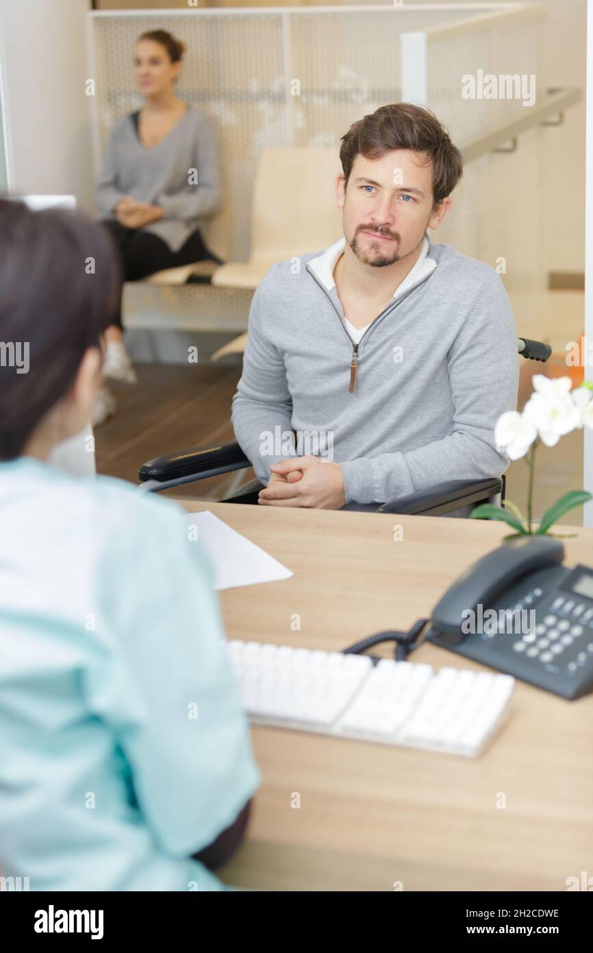 patient in wheelchair at the reception in the hospital Stock Photo - Alamy
