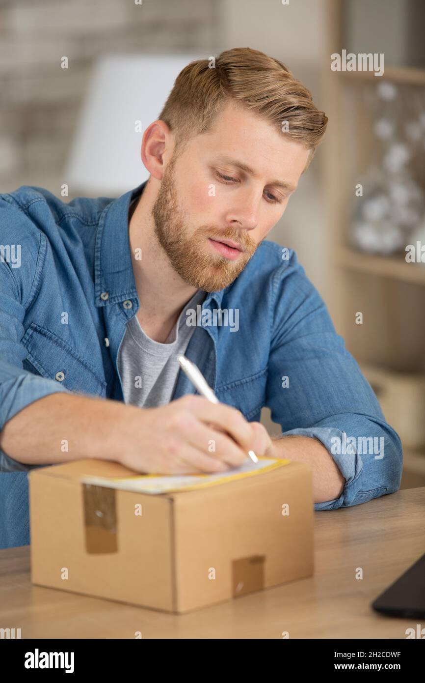 young freight manager checking invoice with cardboard box parcel Stock ...