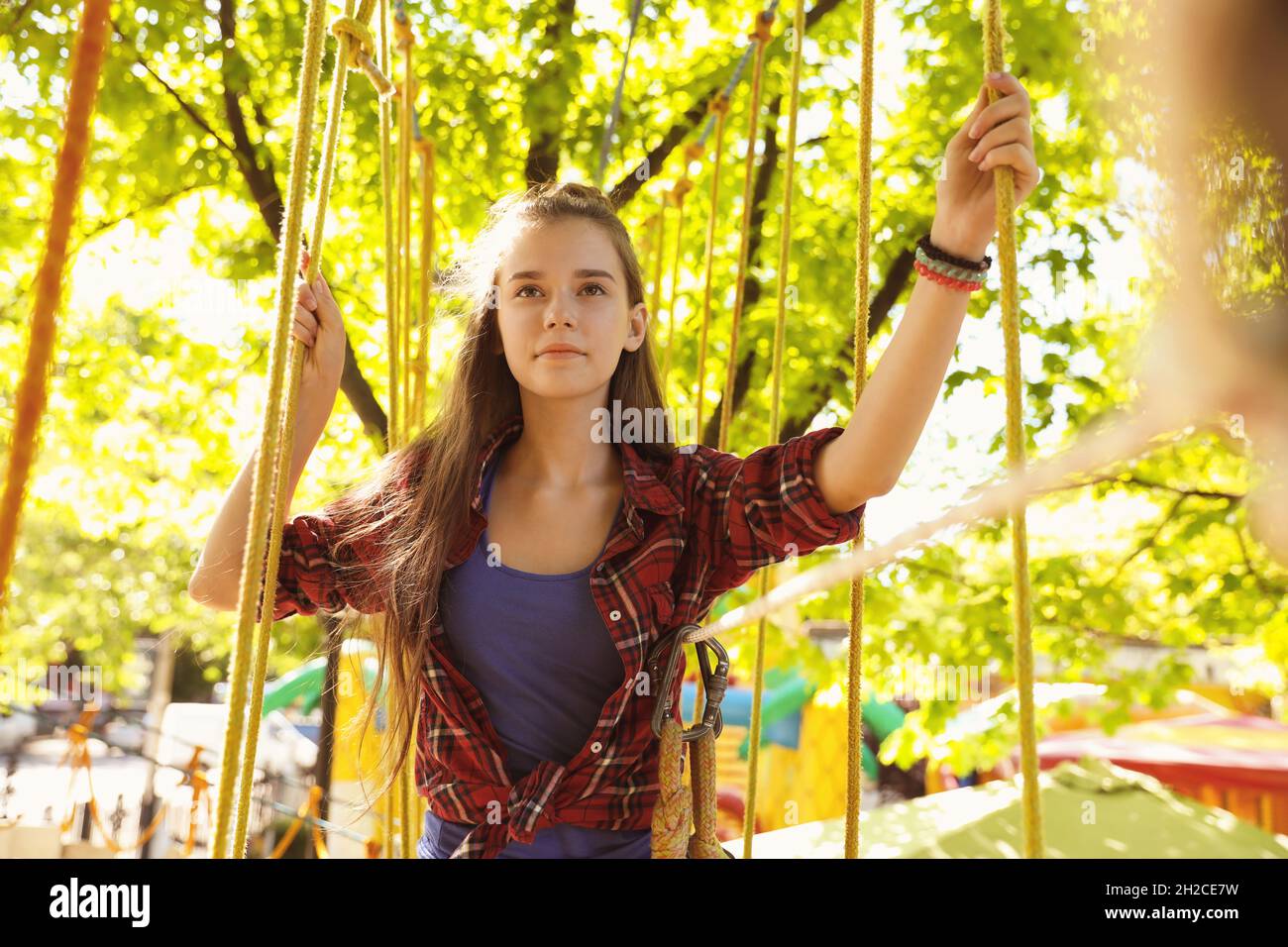Teenage girl climbing in adventure park. Summer camp Stock Photo - Alamy