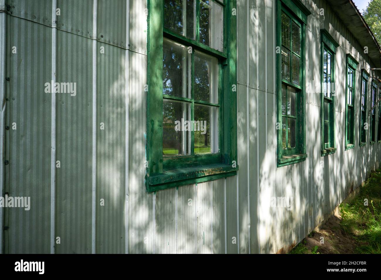 Wall of a village house with green window frames Stock Photo - Alamy