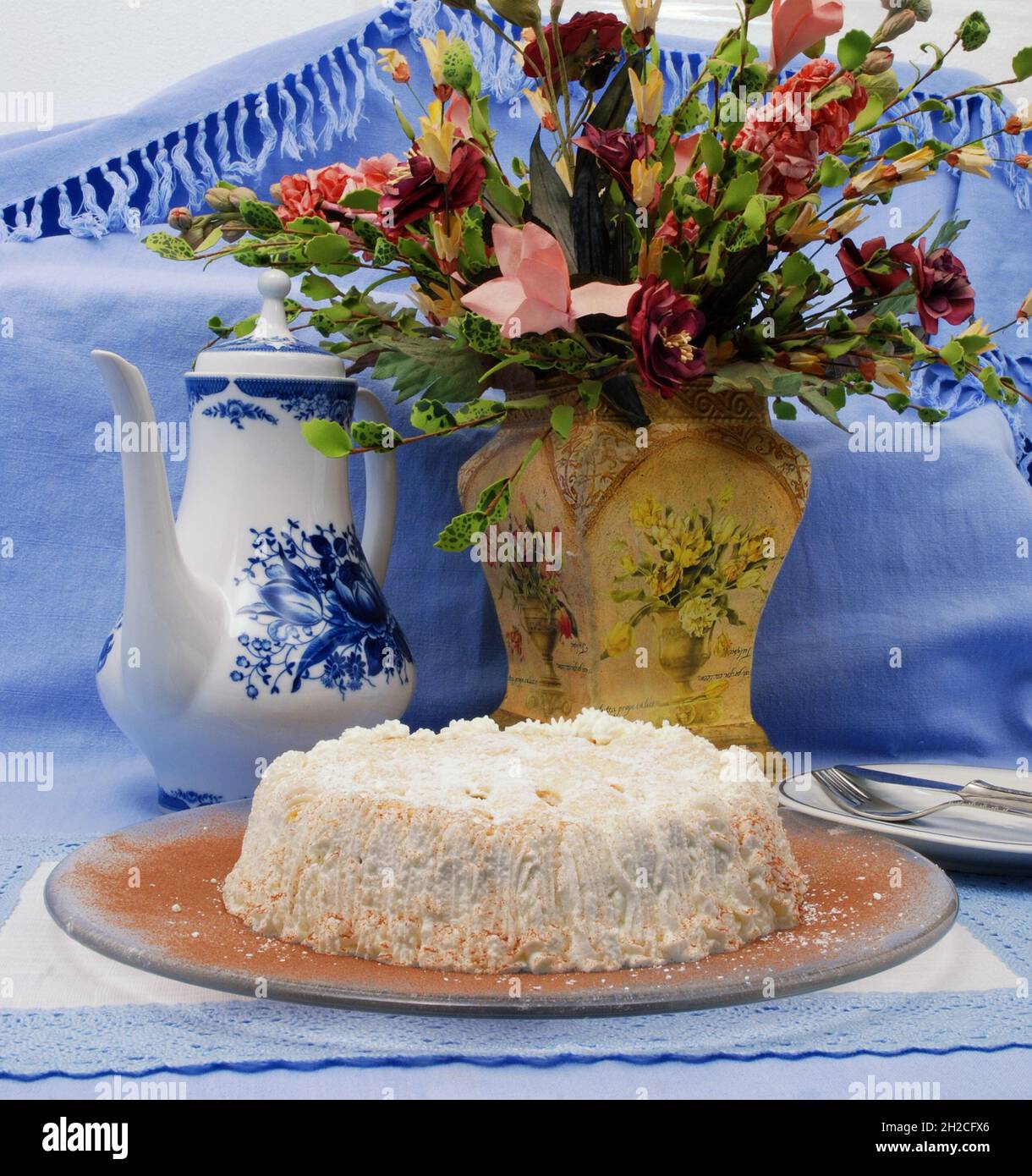 Vertical shot of a traditional Italian diplomatic cake, a vase of ...
