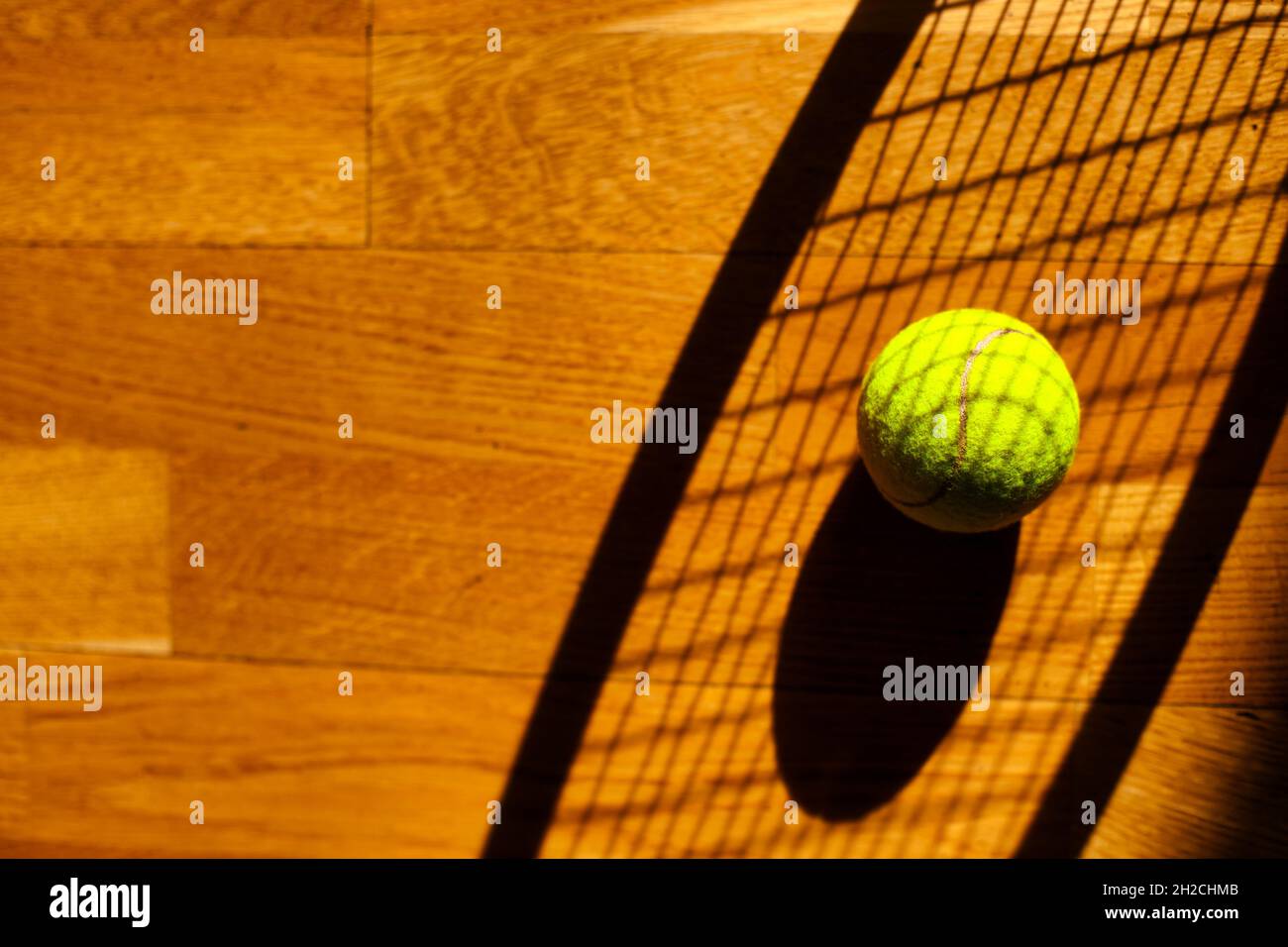 The sight of a tennis ball and the shadow on the floor from a tennis ...