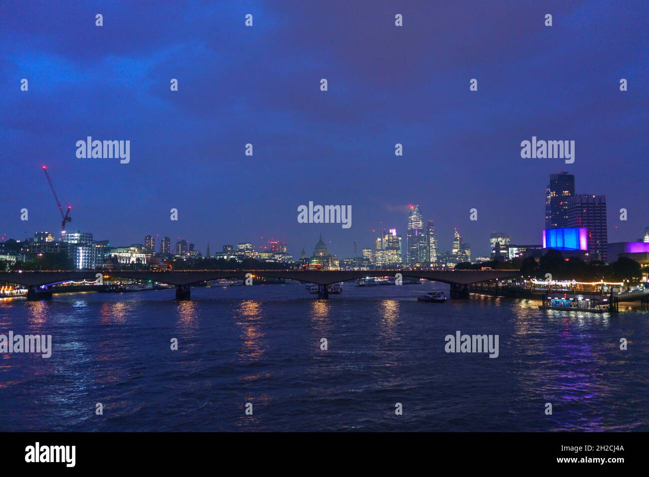 A view of the high rise buildings with their lights on in the city of ...