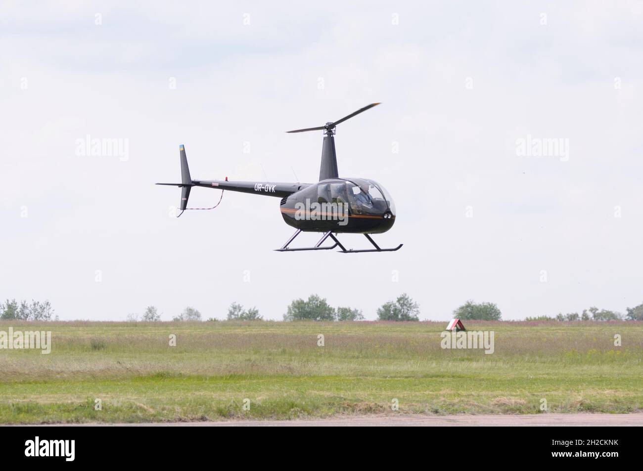 Light helicopter flying above the landing field Stock Photo - Alamy
