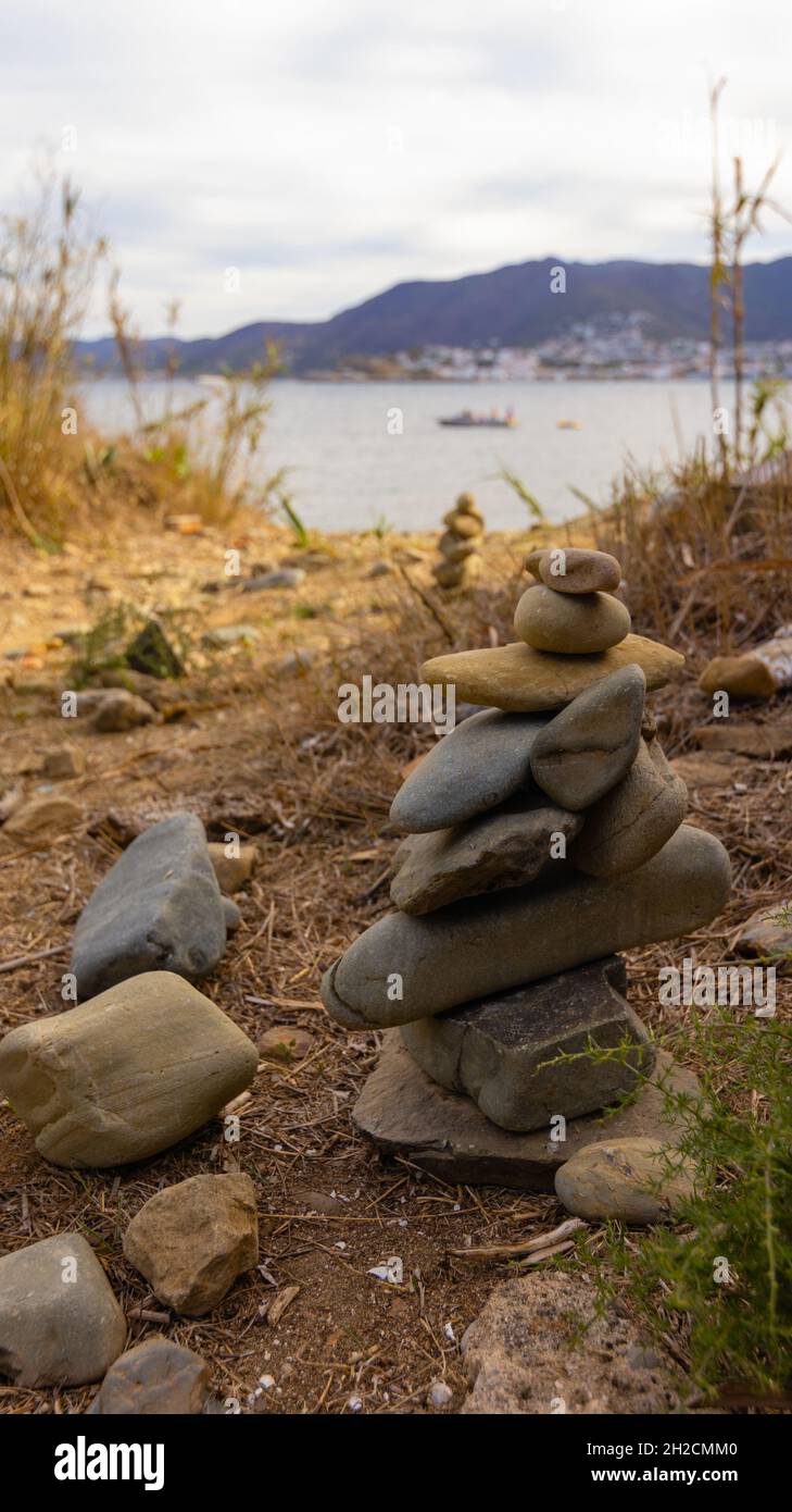 Tower of stones in cala bramant in Llanca Stock Photo - Alamy