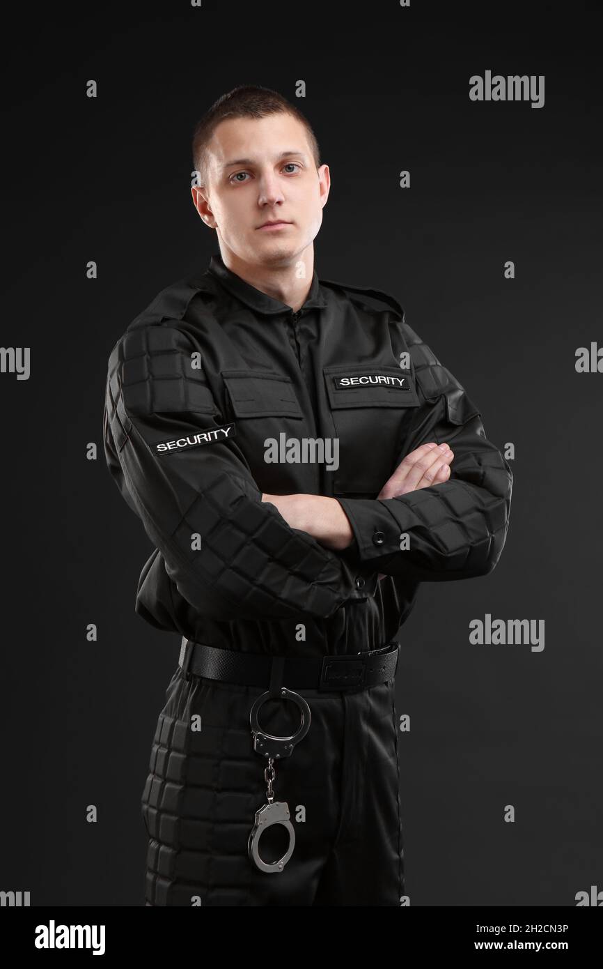 Male security guard in uniform on dark background Stock Photo - Alamy