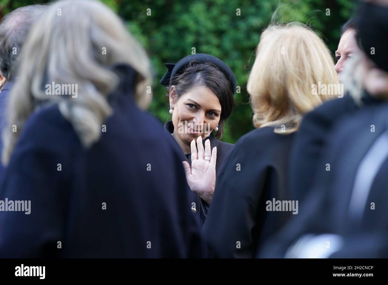 Home Secretary Priti Patel waves to other mourners after the funeral of ...