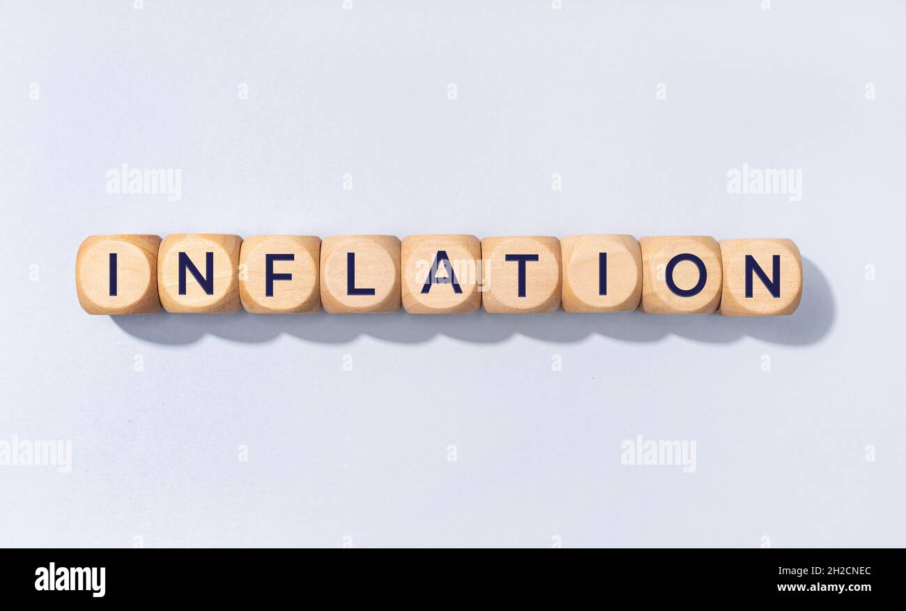 Inflation word on wooden block isolated on gray background Stock Photo ...
