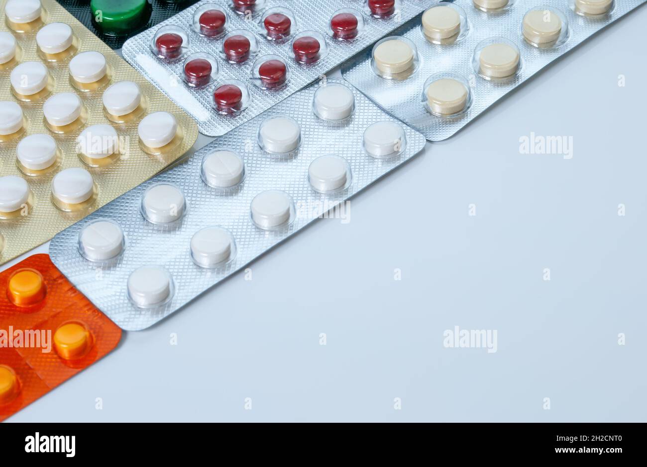 Different pills, tablet's blisters and capsules on white background ...