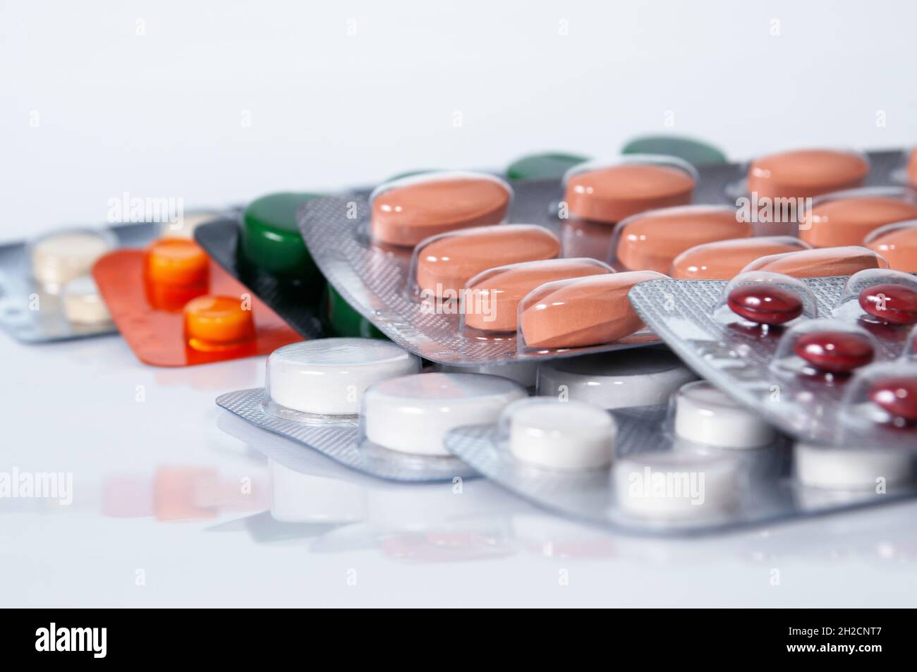 Different pills, tablet's blisters and capsules on white background ...