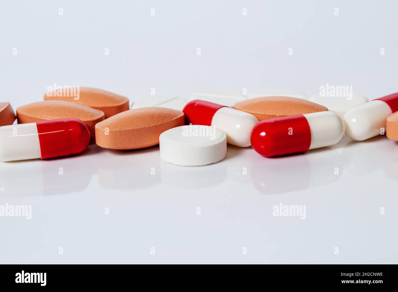 Different pills, tablet's blisters and capsules on white background ...