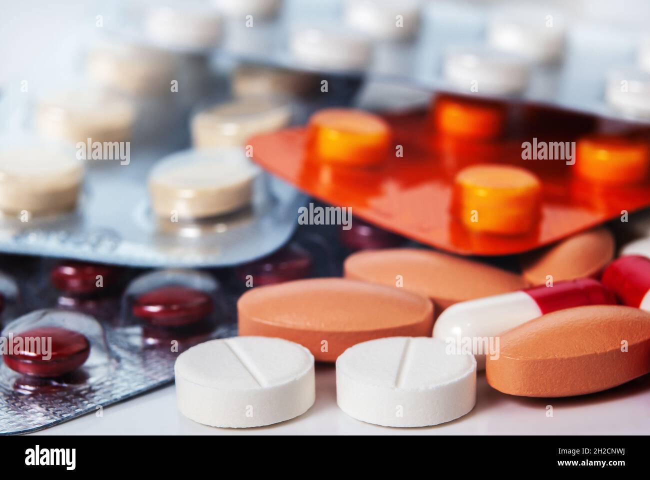 Different pills, tablet's blisters and capsules on white background ...