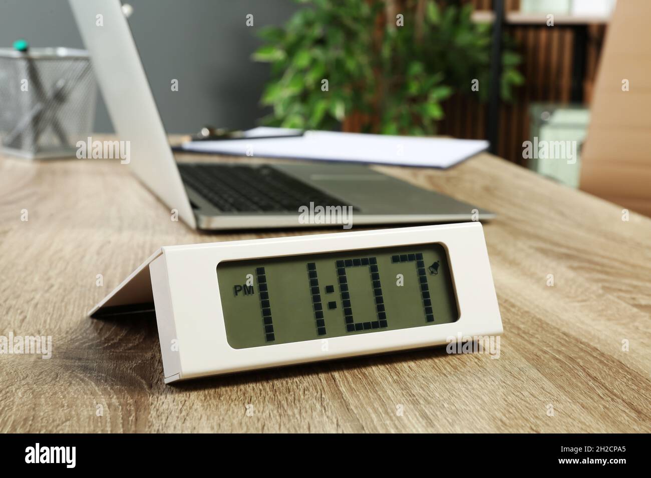 Digital clock on table in office. Time management Stock Photo - Alamy