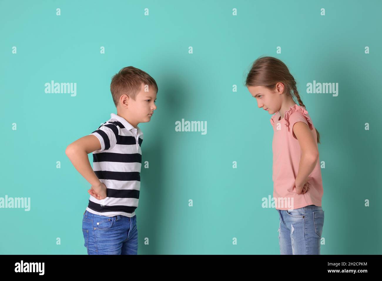 Brother arguing with sister on color background Stock Photo - Alamy