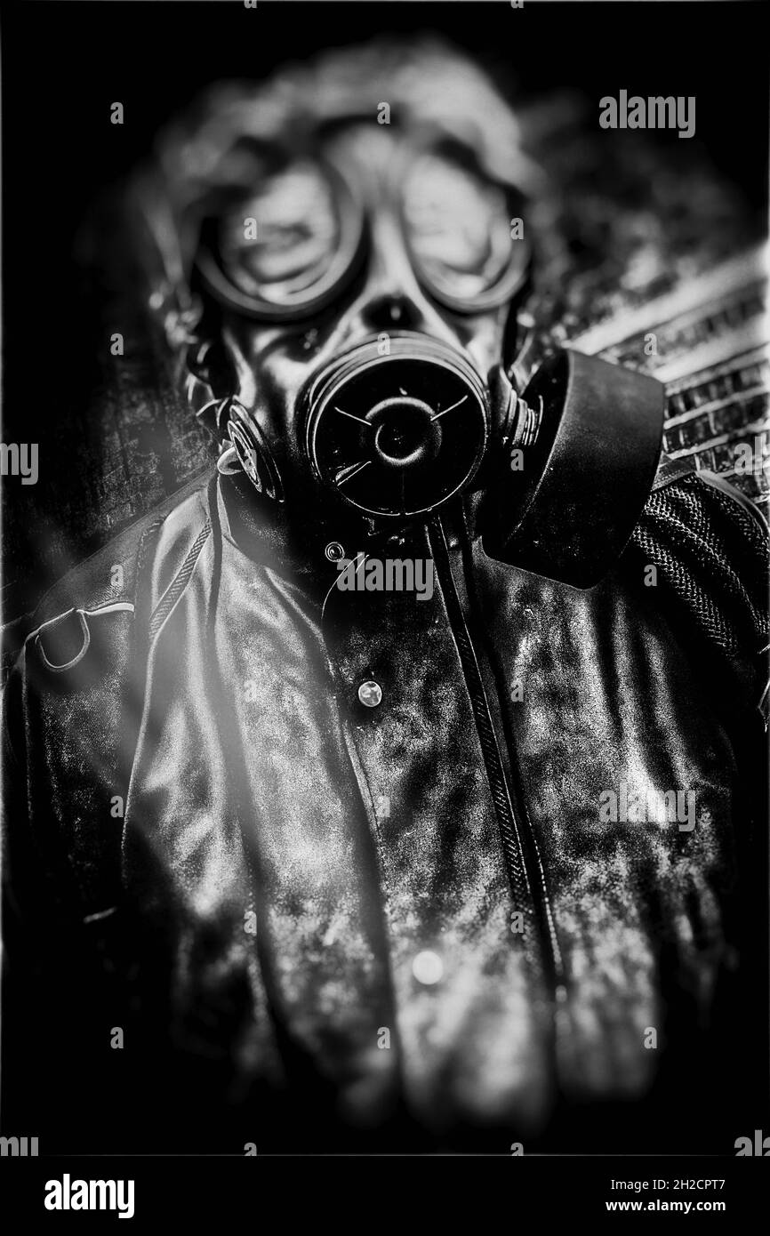 Person wearing a biohazard suit with gas mask, standing in the entrance ...