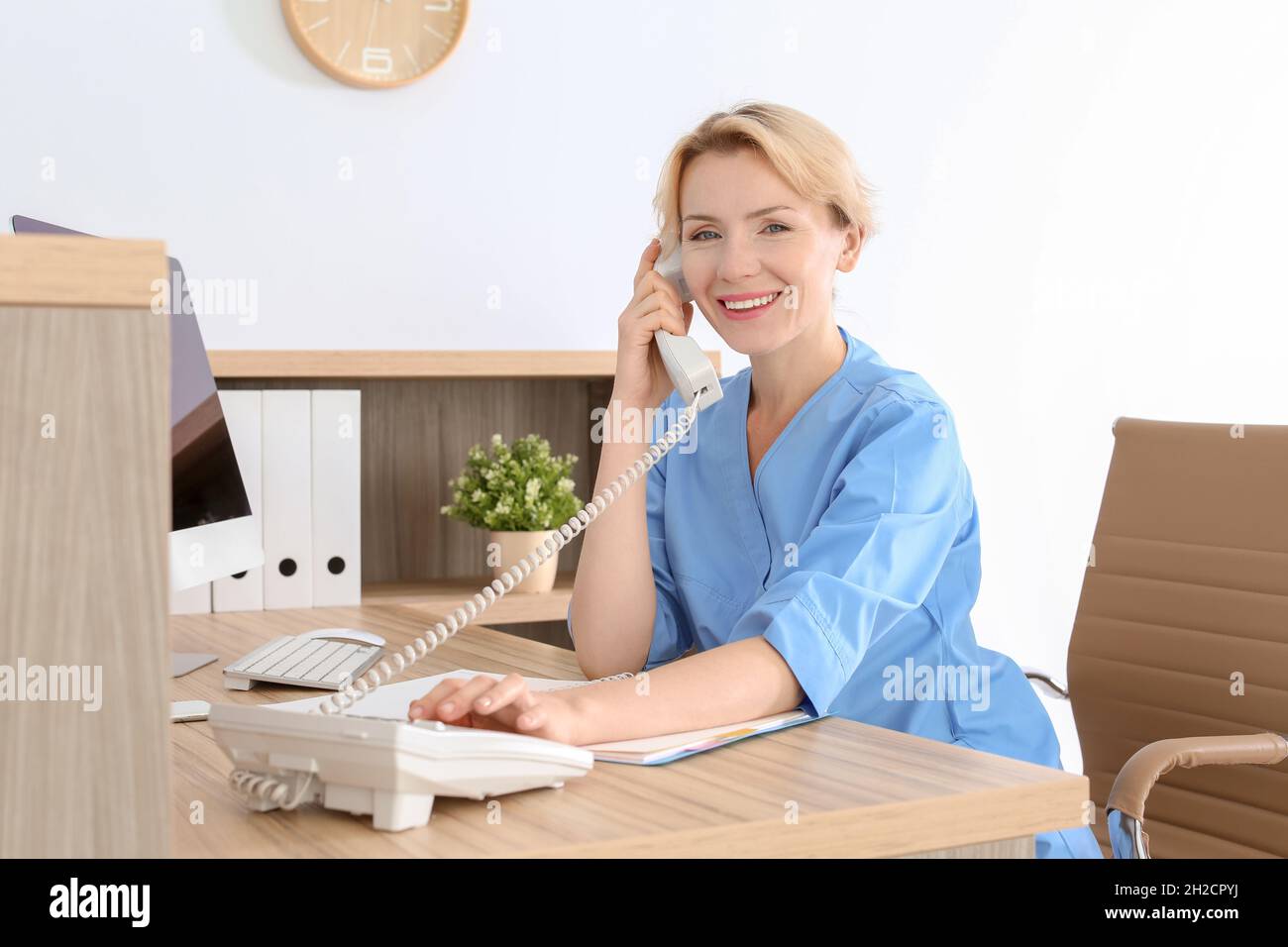 Female medical assistant at workplace in clinic. Health care service ...