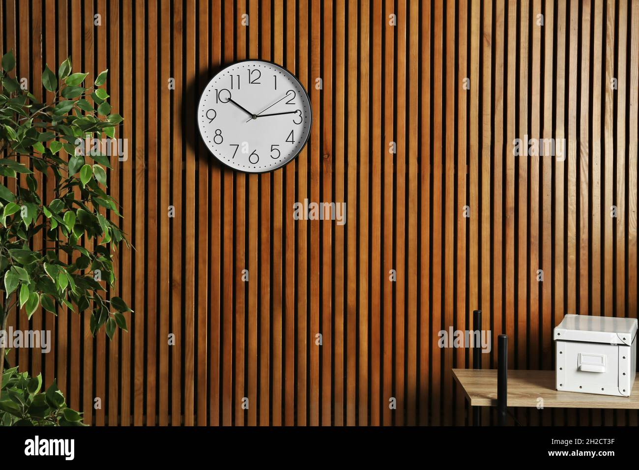 Room interior with clock and space for text on wooden wall. Time ...