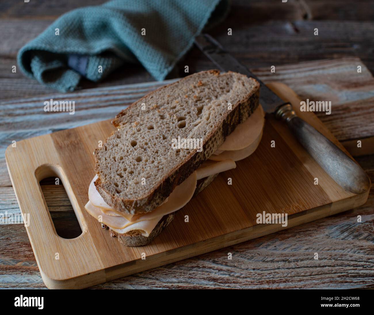 Rustic sandwich, farmhouse style with butter and ham. Served on wooden ...