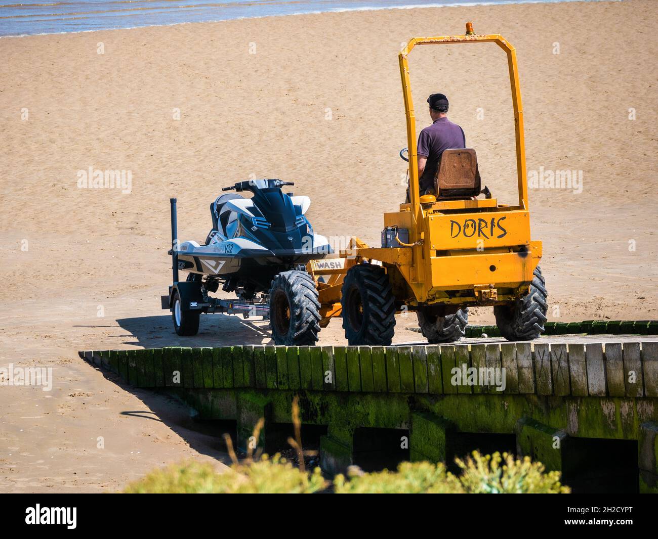 Small yellow tractor towing a Jet Ski on Greatstone Beach Stock Photo ...