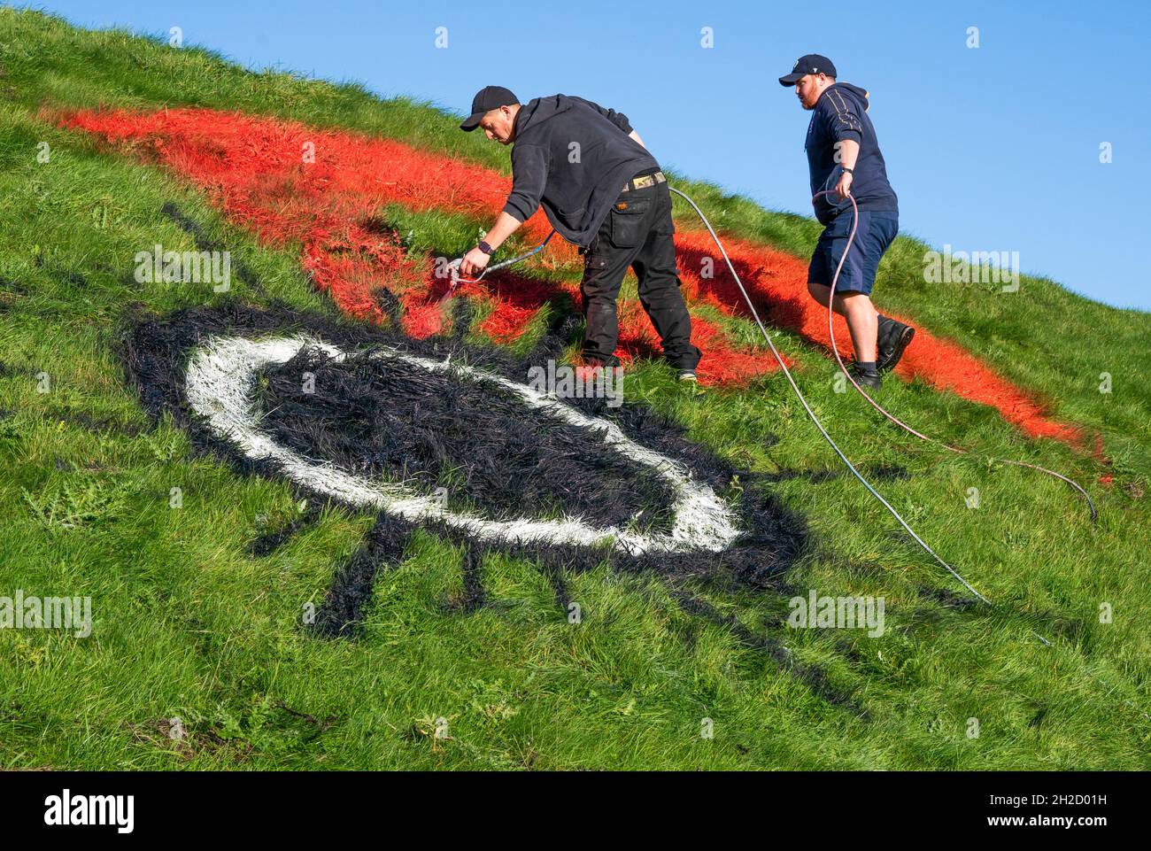 Giant poppies are painted onto the grass pyramids alongside the M8 ...