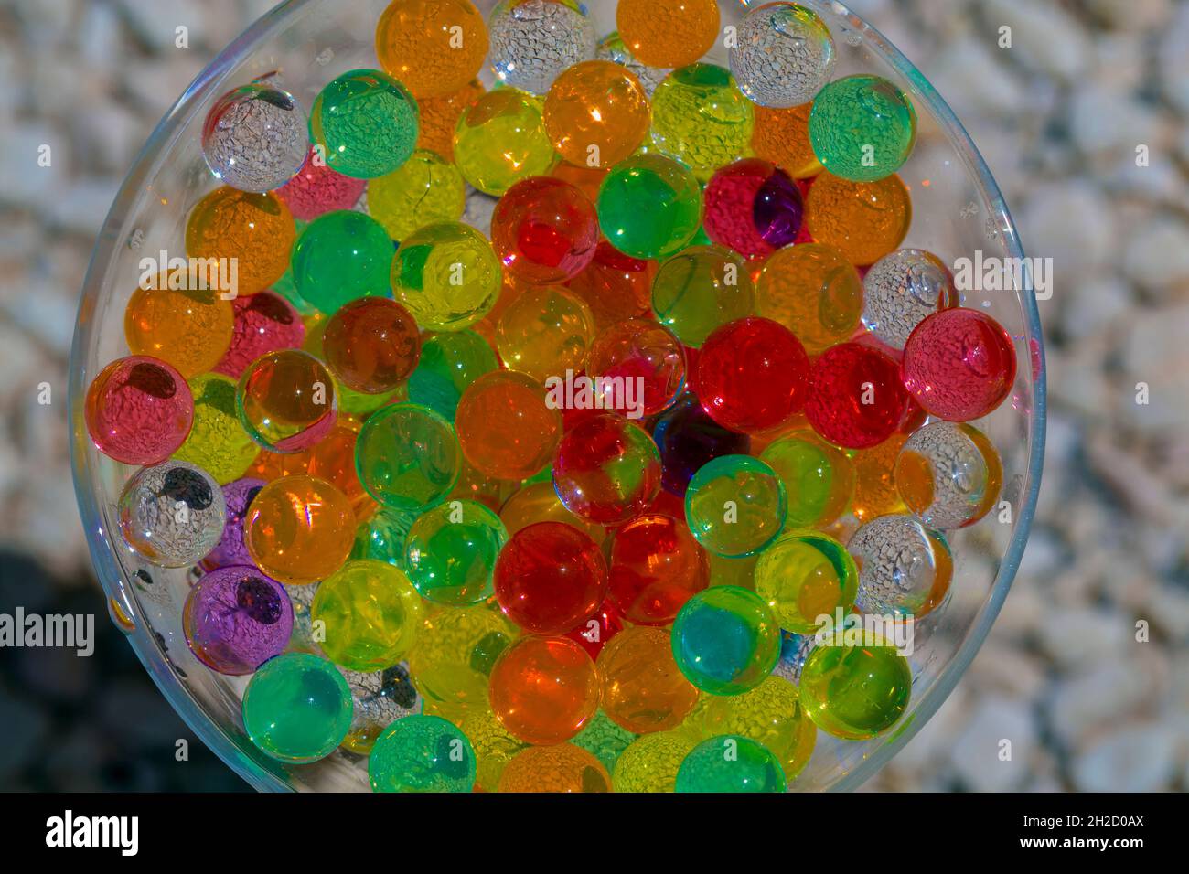 close-up of semitransparent colored balls in glass container. concept ...