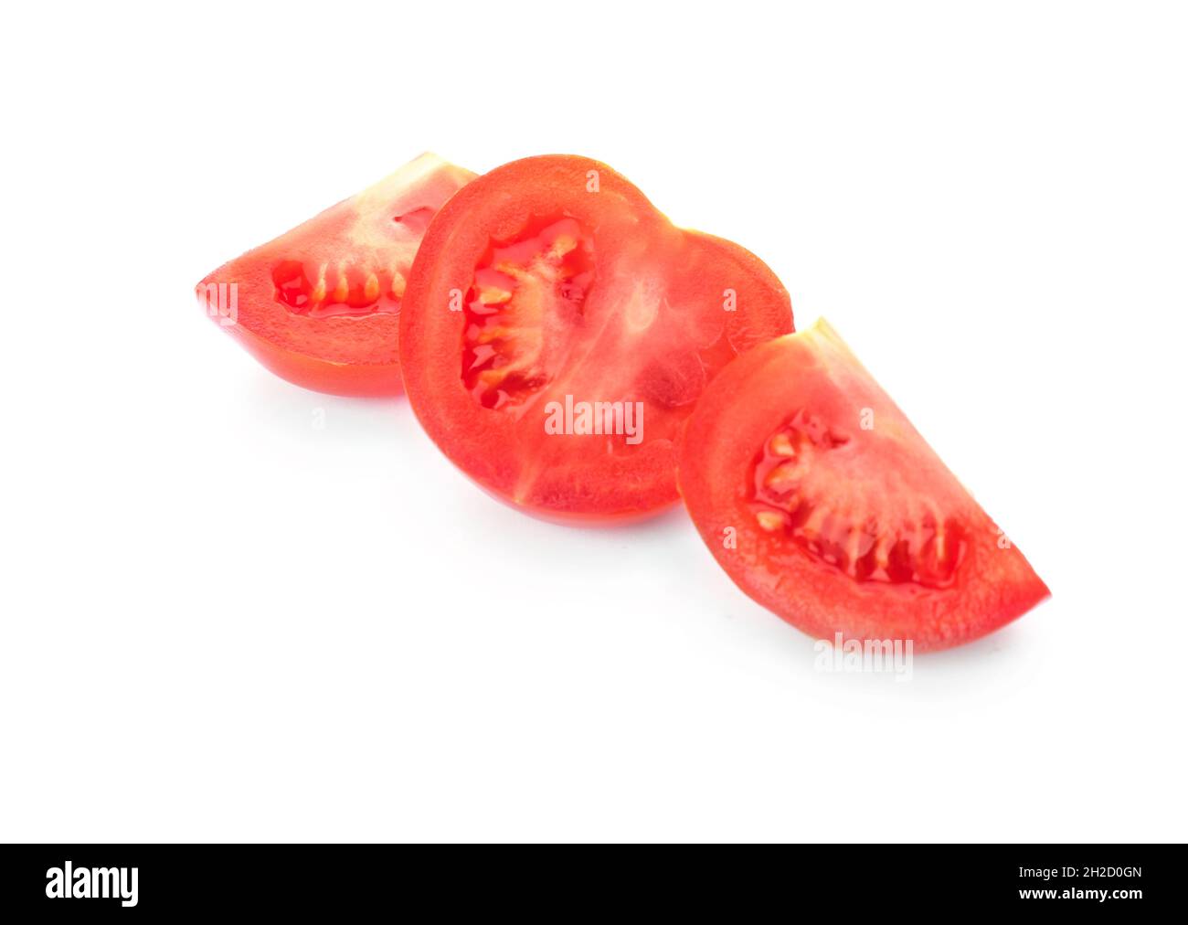 Cut red tomato on white background Stock Photo - Alamy