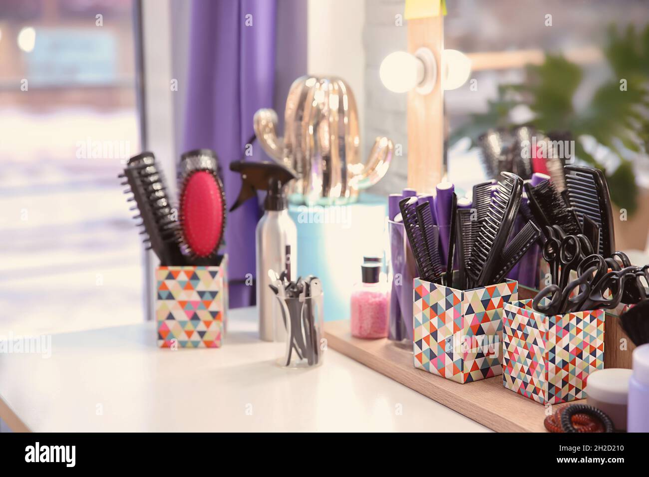 Set of hairdresser tools on table in salon Stock Photo - Alamy