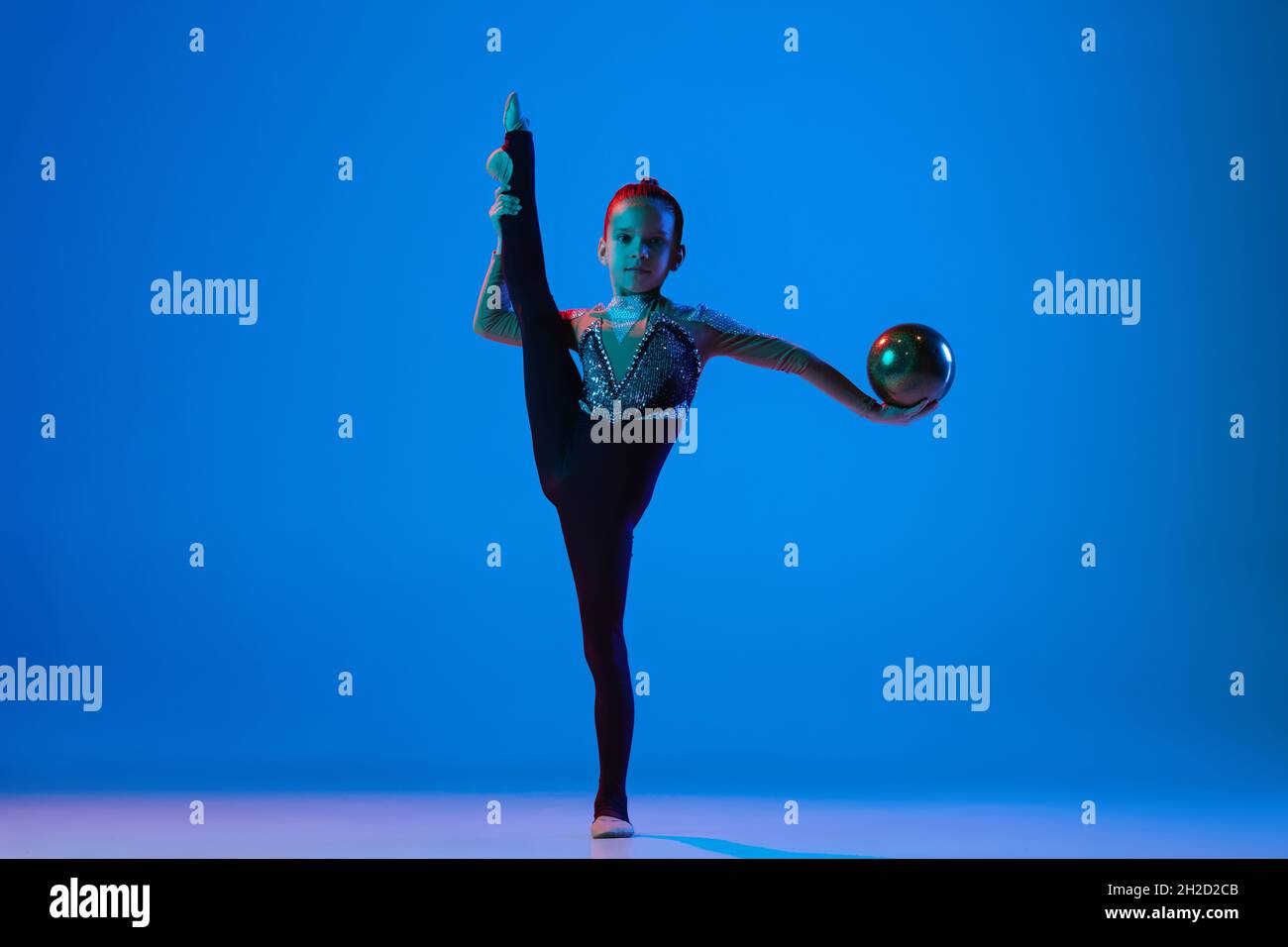 Full-length portrait of little girl, professional rhythmic gymnast ...