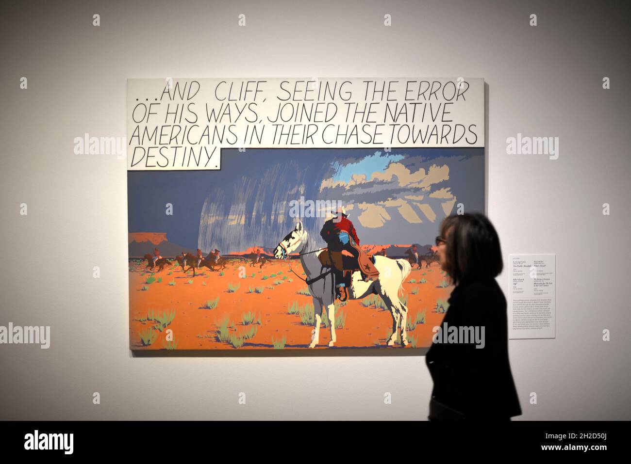 A museum visitor admires a painting titled "Cliff" by artist Billy ...