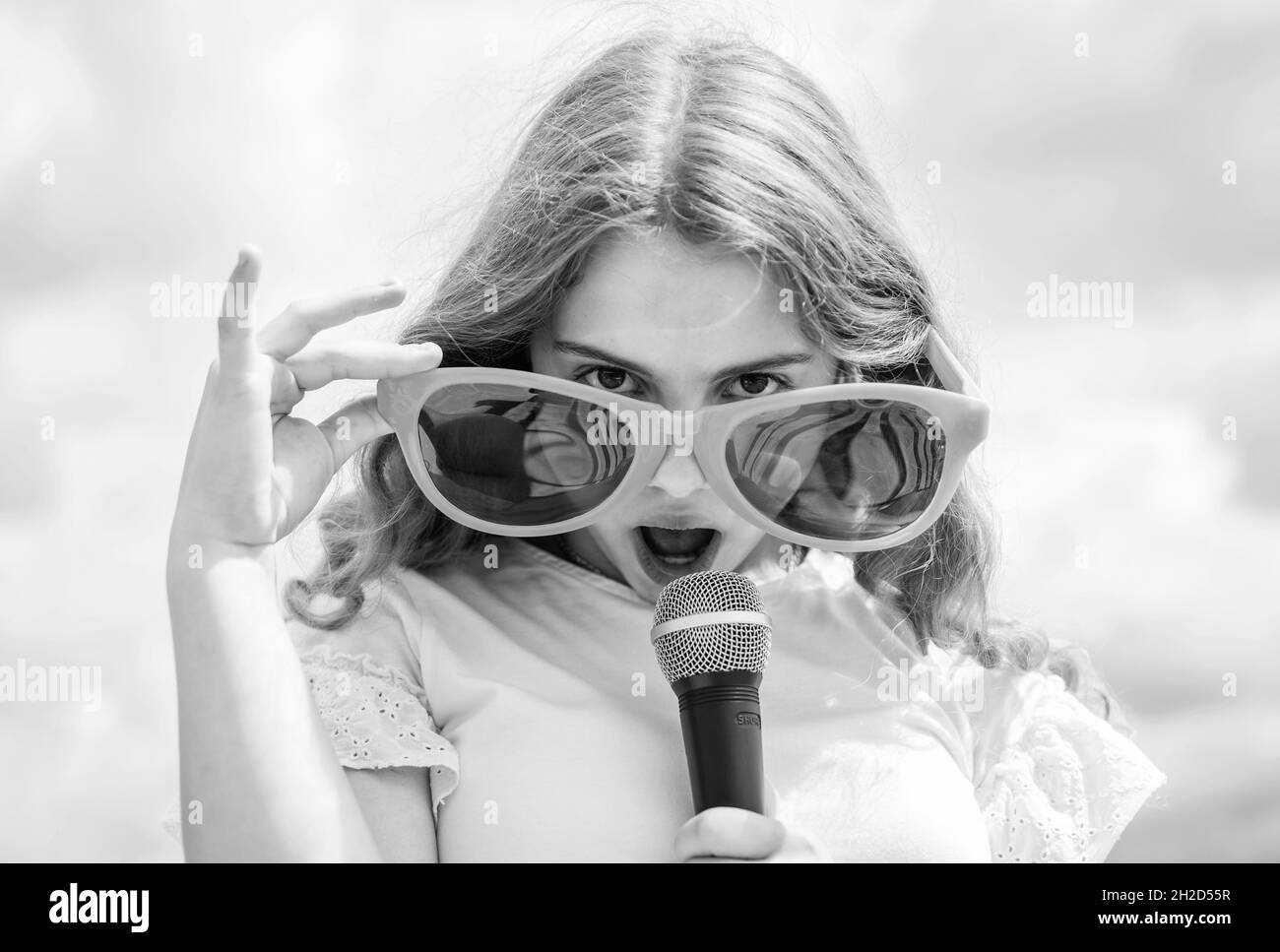 Everyone deserves good music. singer in glasses with microphone. happy ...