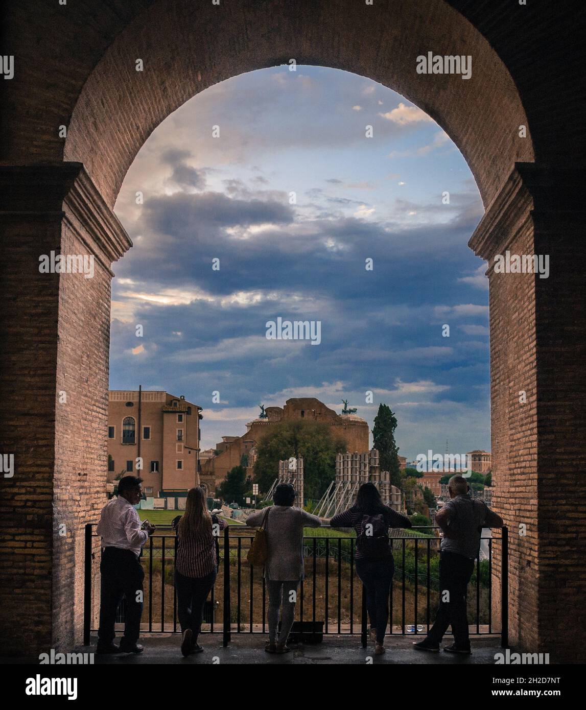 Rear view of tourist leaning on railing of the Colosseum in Rome Stock ...