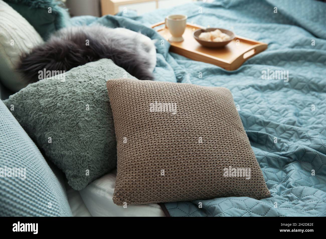 Different pillows on bed in room. Idea for interior decor Stock Photo ...