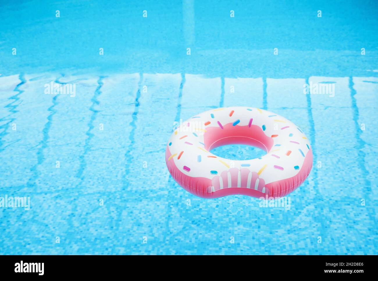 Inflatable ring floating on water in swimming pool Stock Photo - Alamy