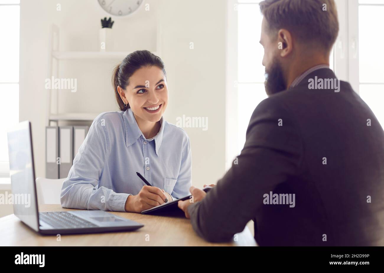 Woman talking to male customer desk hi-res stock photography and images ...