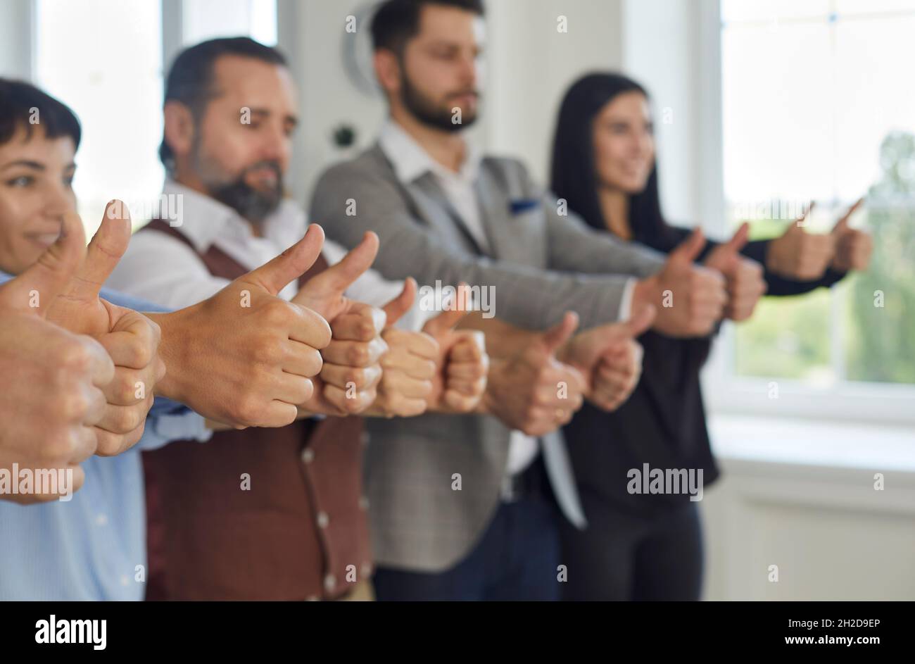 Close up of thumbs up business people showing gesture recommendation or ...