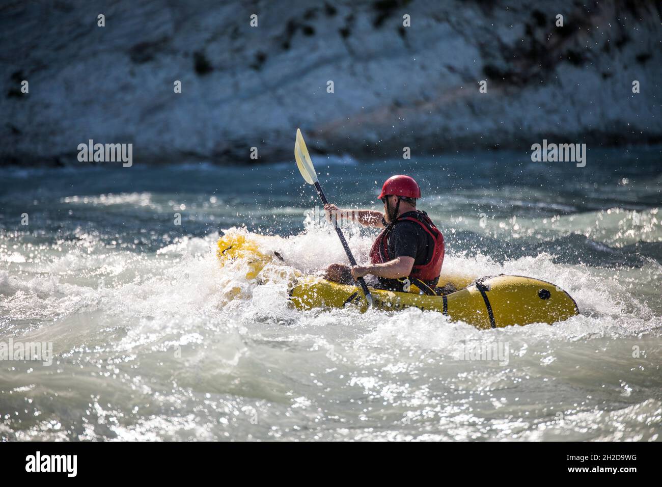 Side view of man rafting through white water rapids Stock Photo - Alamy