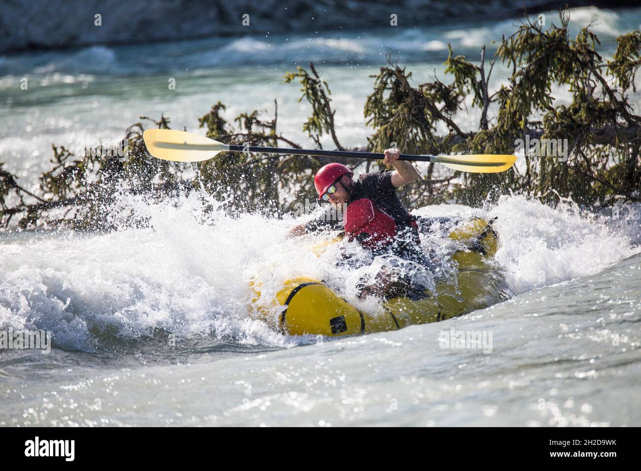 Man paddling white water raft flips after hitting huge rapid Stock ...