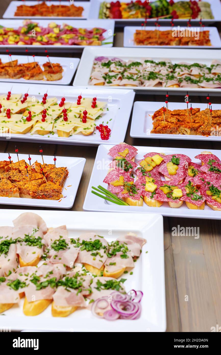 plates with different appetizers on a table of a buffet Stock Photo - Alamy