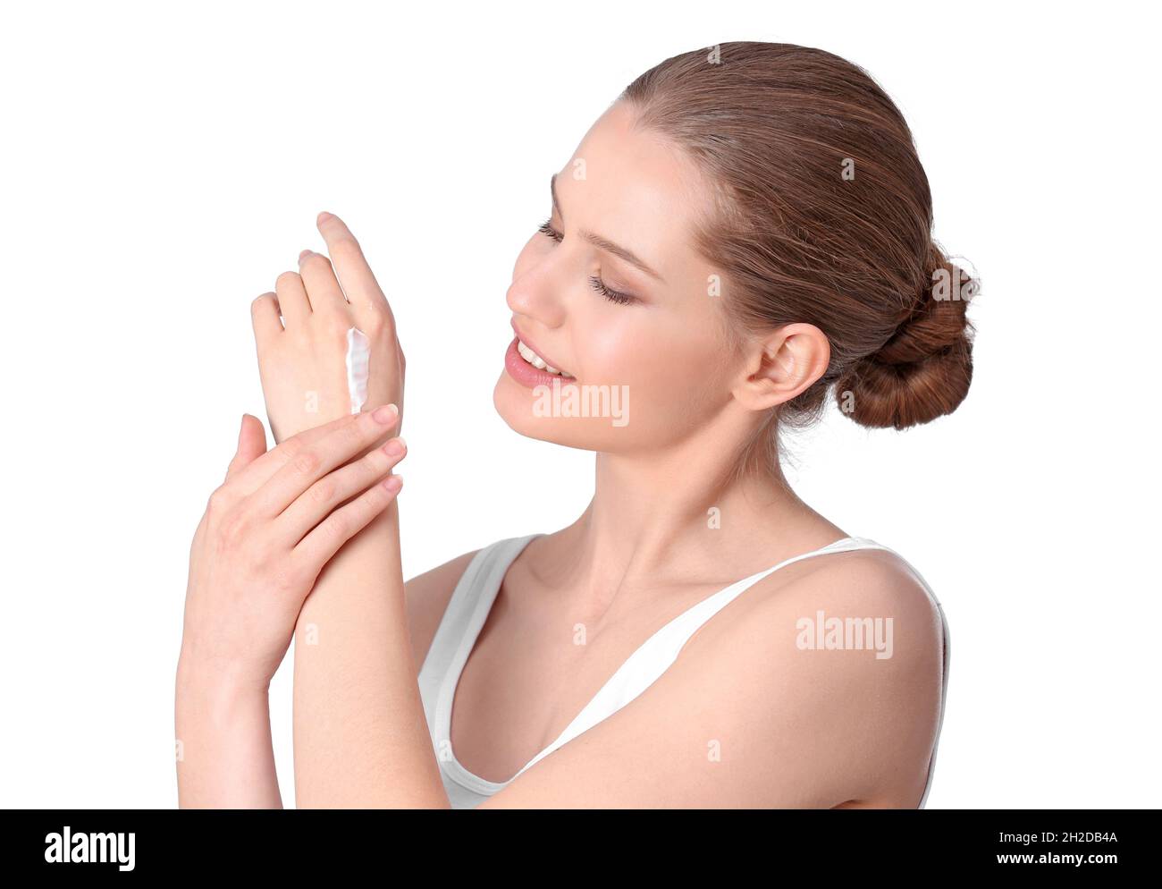 Young woman applying hand cream on white background Stock Photo - Alamy