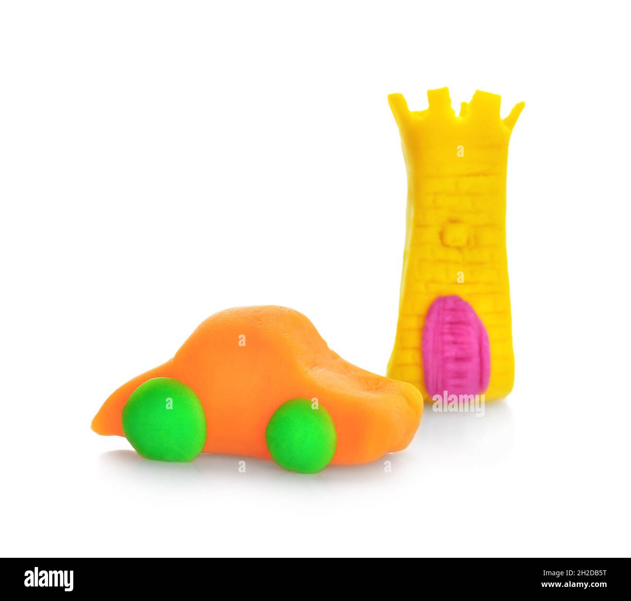 Medieval tower and car made from play dough on white background Stock ...