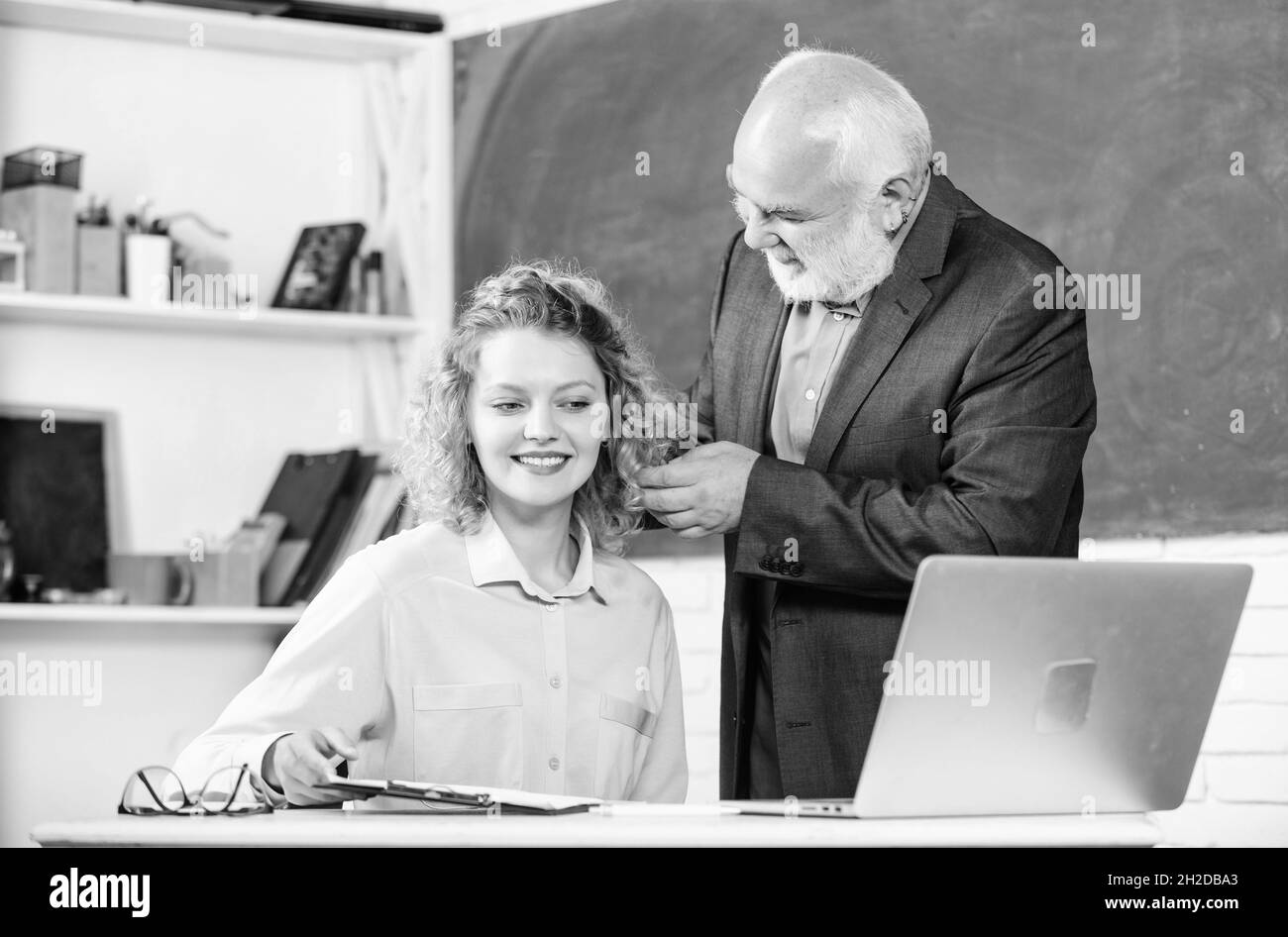 Final test and graduation. Lecturer educator helping student with test ...