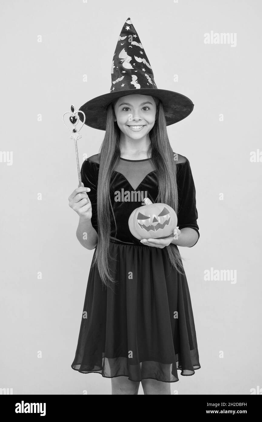 spell. child in witch hat with pumpkin. kid create miracles with magic ...