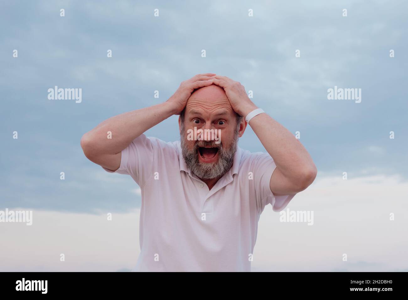 Happy Senior man with hands up outside Stock Photo - Alamy